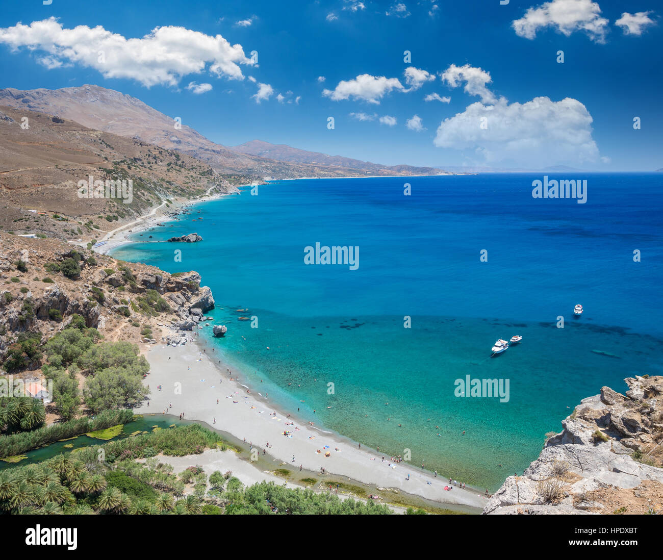 Preveli Beach in Crete island, Greece. There is a palm forest and a ...