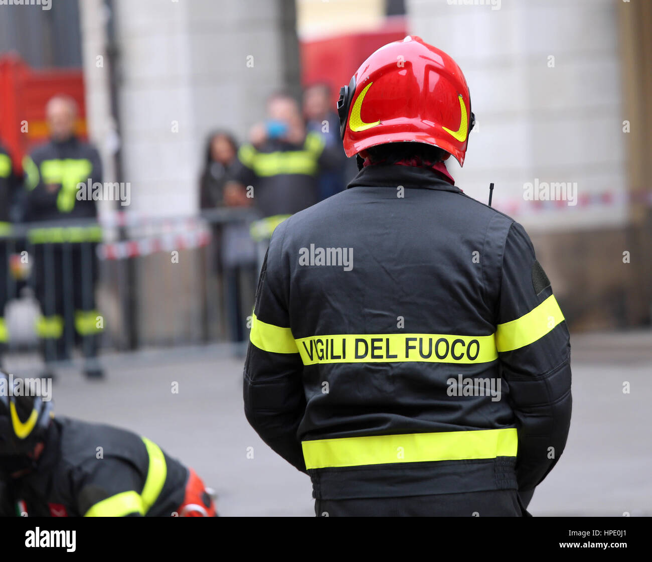 Italian firefighter with protective helmet and the word VIGILI DEL ...