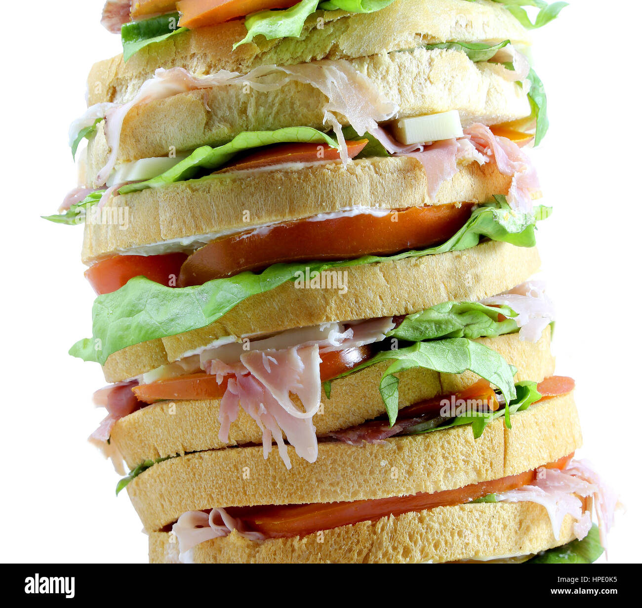 big sandwich with cheese and ham and tomato and mayonnaise on a wooden ...