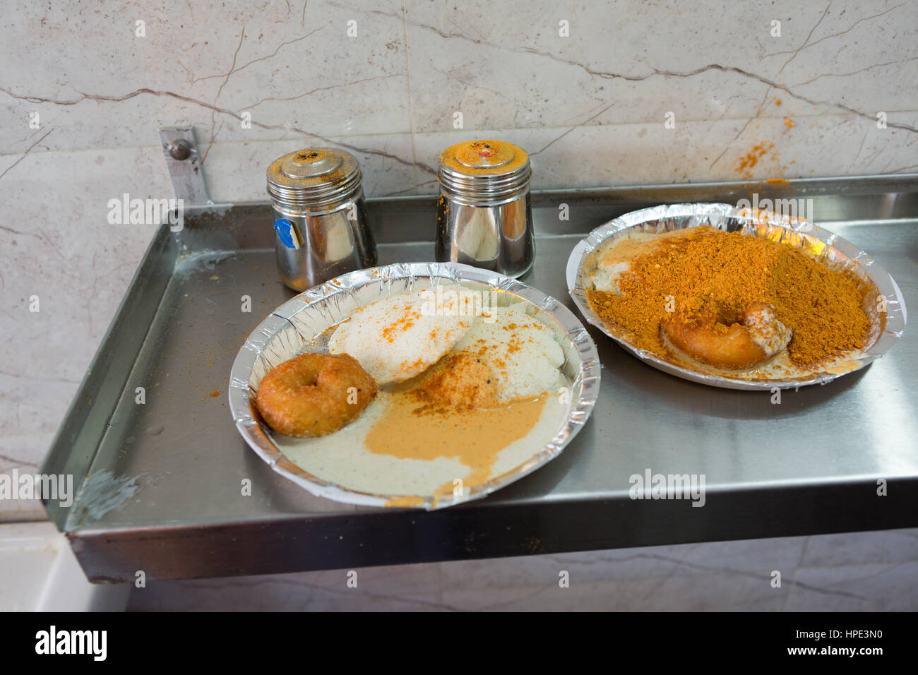 Idli and Wada with Chutney and Gun Powder on aluminium paper plate ...