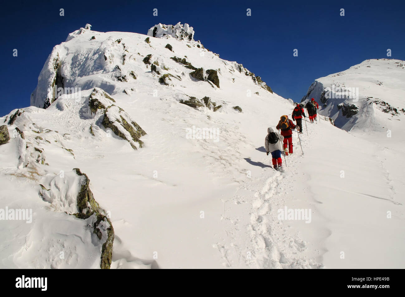 Group of people hiking in beautiful winter mountains Stock Photo - Alamy
