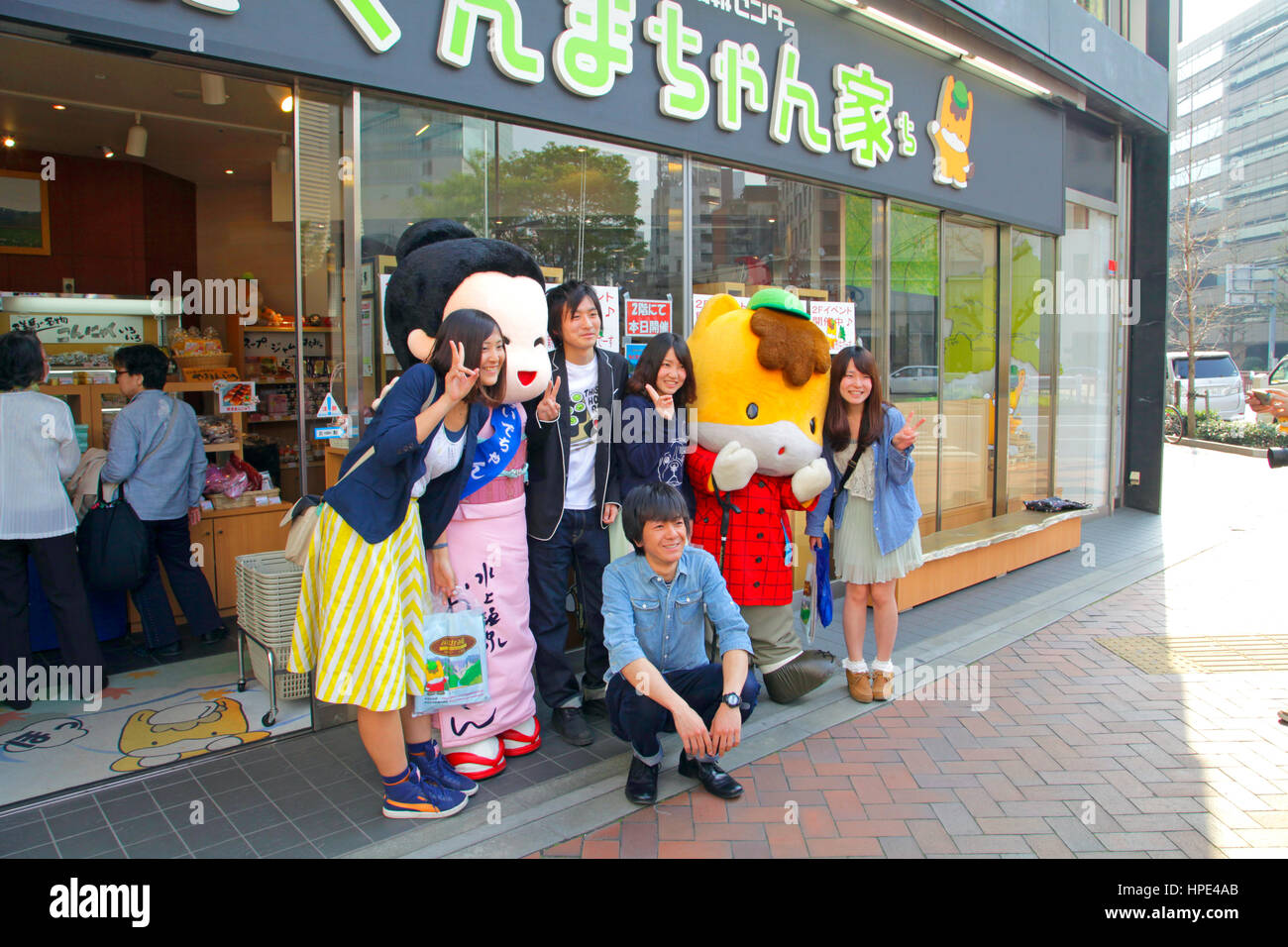 People Taking Group Photographs in Front of Local Gunma Speciality ...