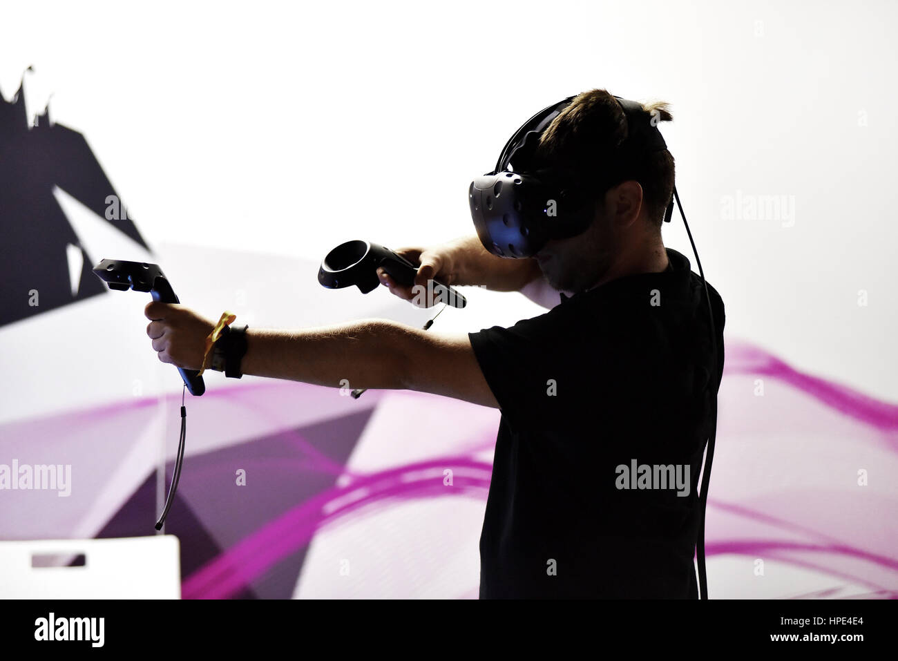 Guy playing with virtual reality headset and hand controls Stock Photo ...