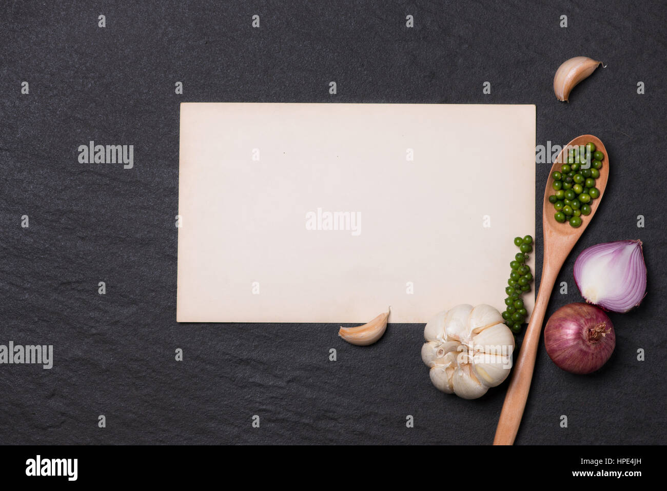 Vegetable recipe. Open menu book with fresh herbs and spices on dark ...