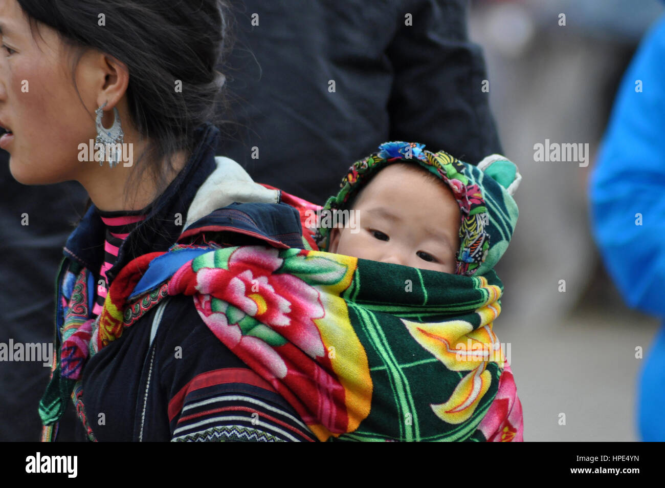 Mother carrying traditional baby carrier hi-res stock photography and ...