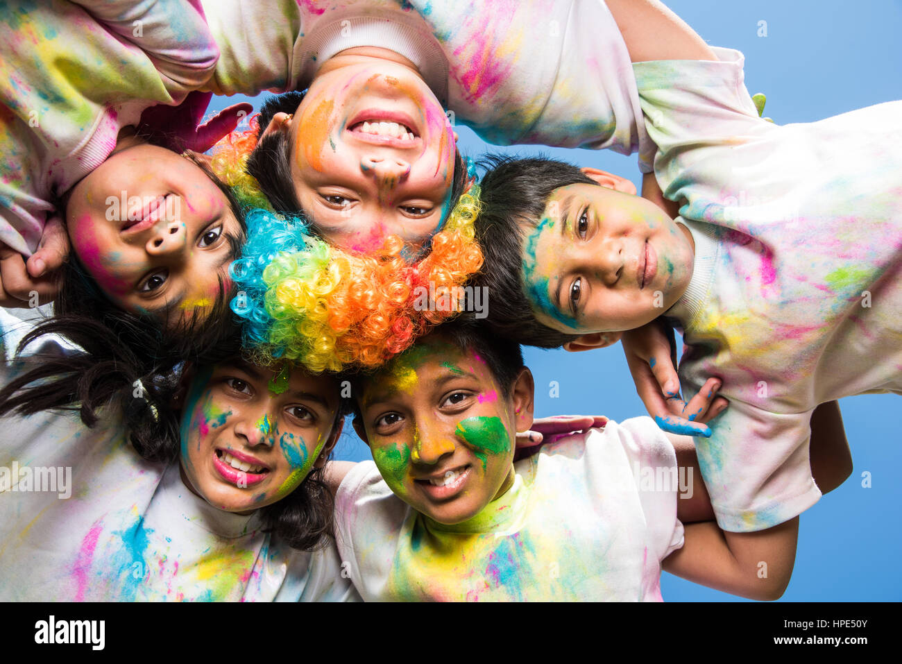 five or 5 cute little indian kids playing with colours or asian ...