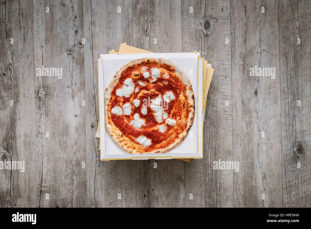 Stacked pizza boxes and tasty pizza on top, take away food concept ...