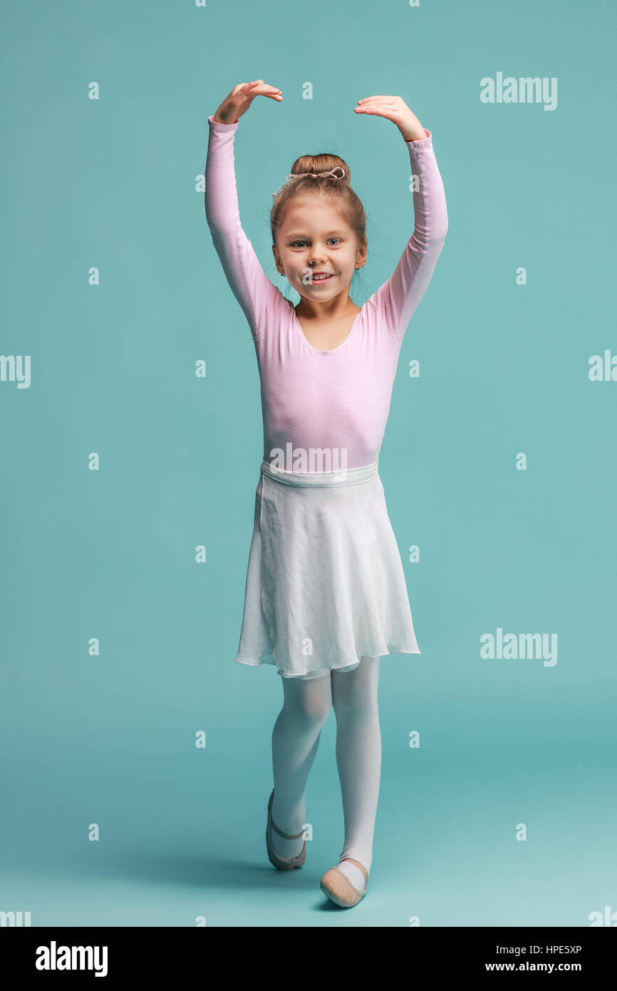 The little girl as balerina dancer on blue studio background Stock ...