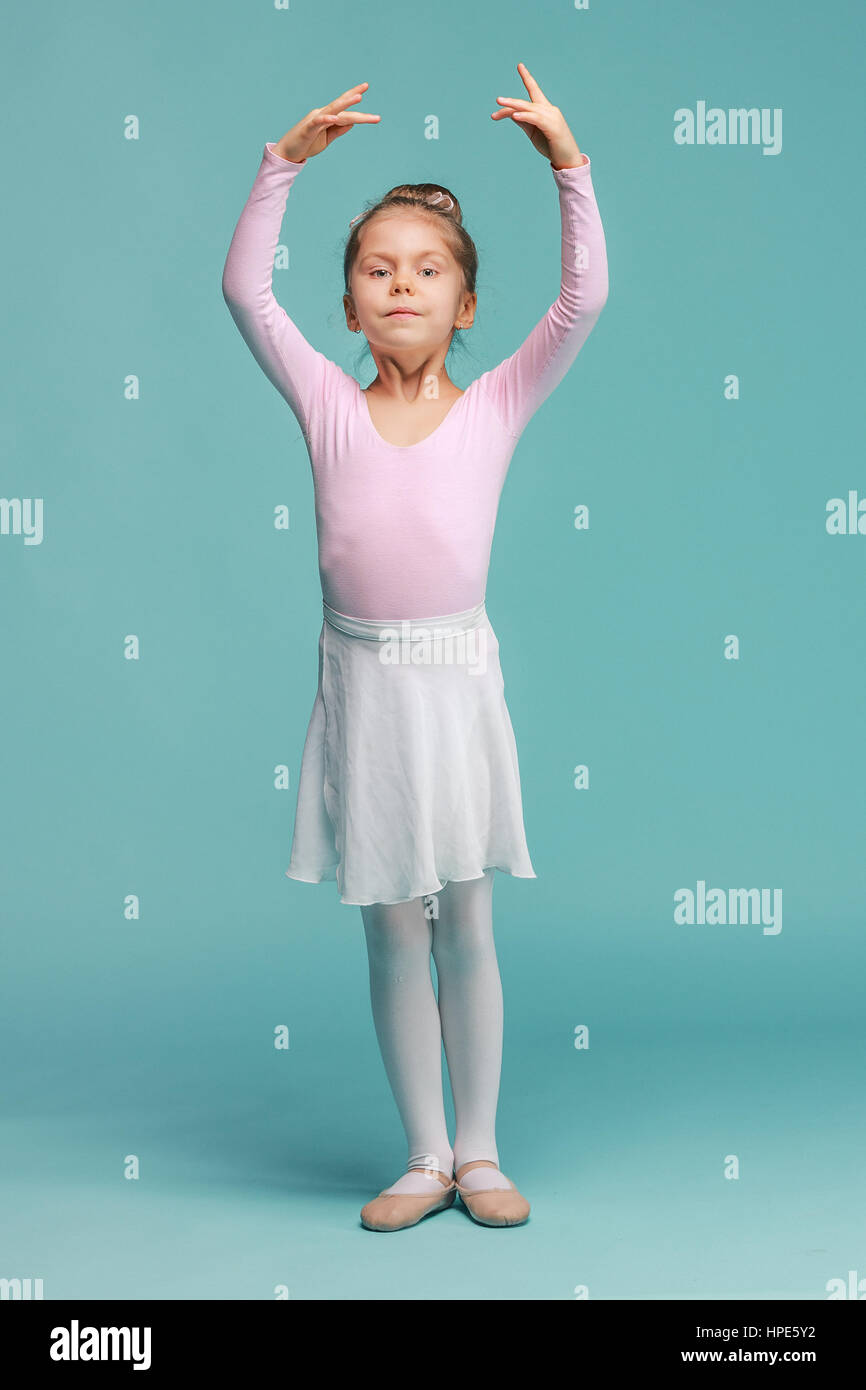 The little girl as balerina dancer on blue studio background Stock ...