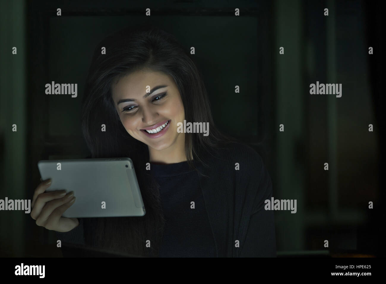 Woman smiling using digital hi-res stock photography and images - Alamy