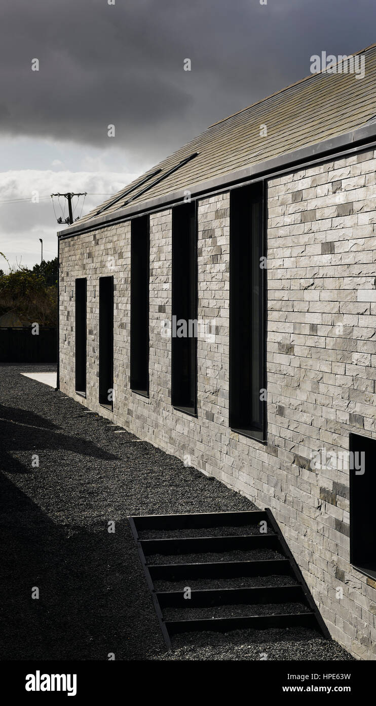 View of rear facade with ground level change and steps. Killowen House ...