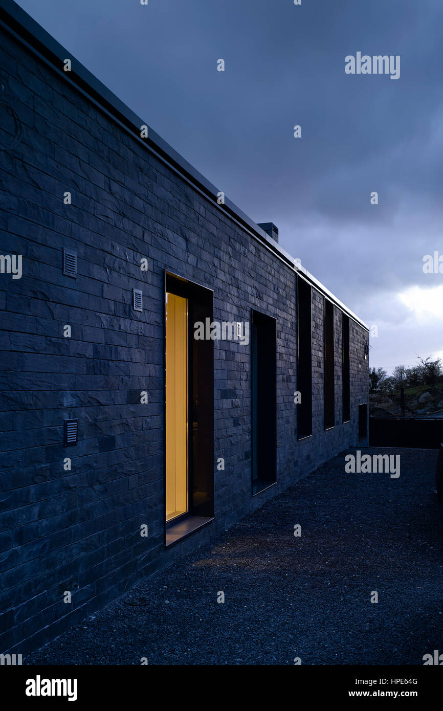 Dusk view of rear facade showing window rythm. Killowen House ...