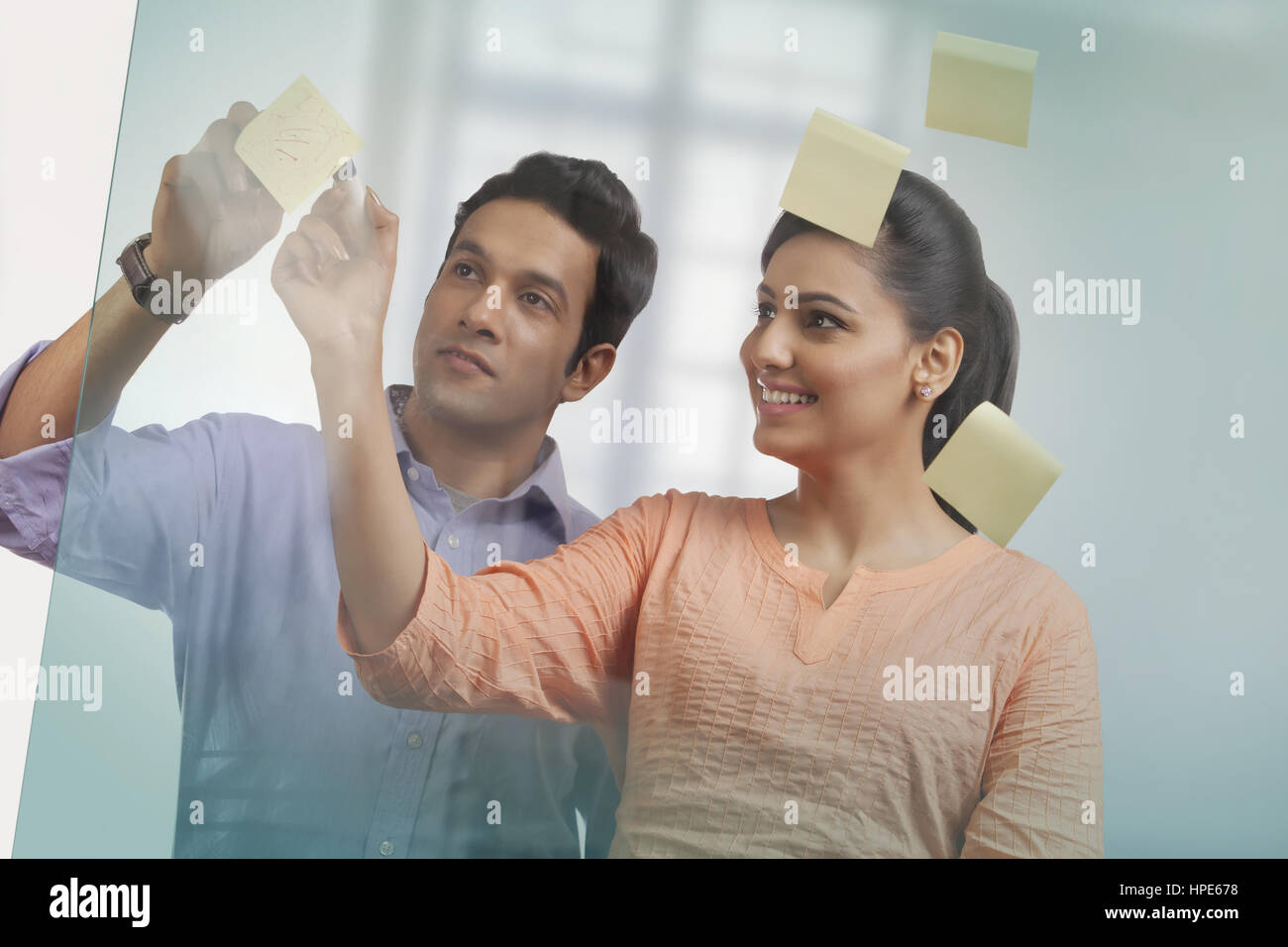 Smiling colleagues looking work hi-res stock photography and images - Alamy