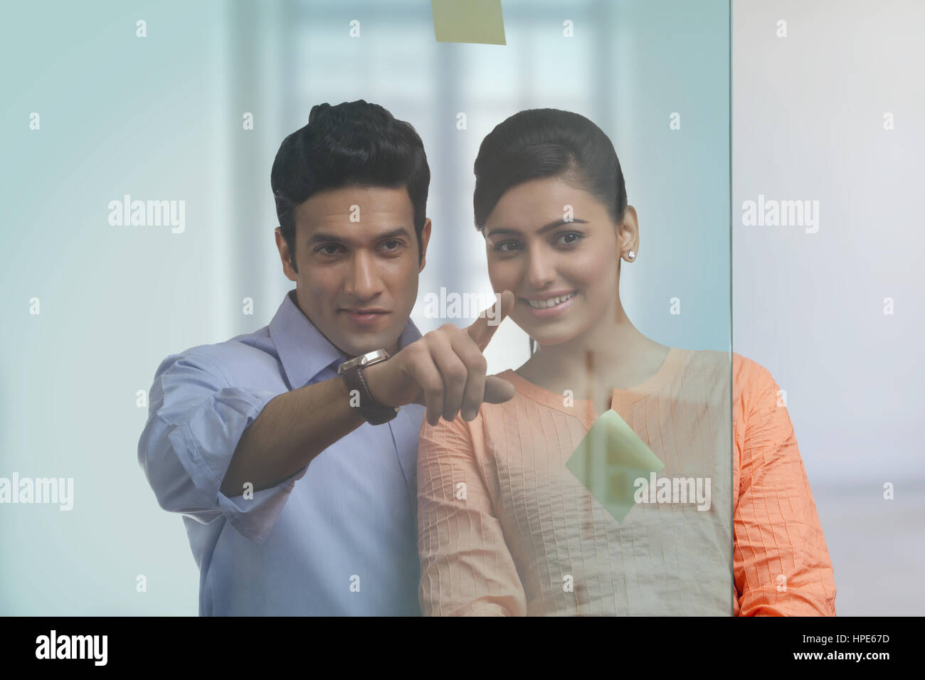 Smiling colleagues looking work hi-res stock photography and images - Alamy