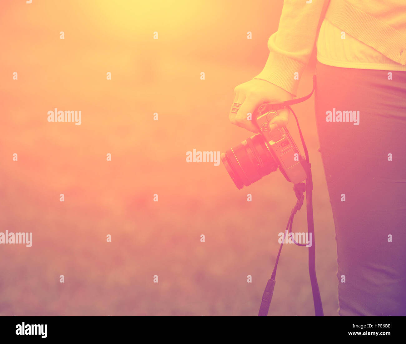Woman with retro camera in sunset Stock Photo - Alamy