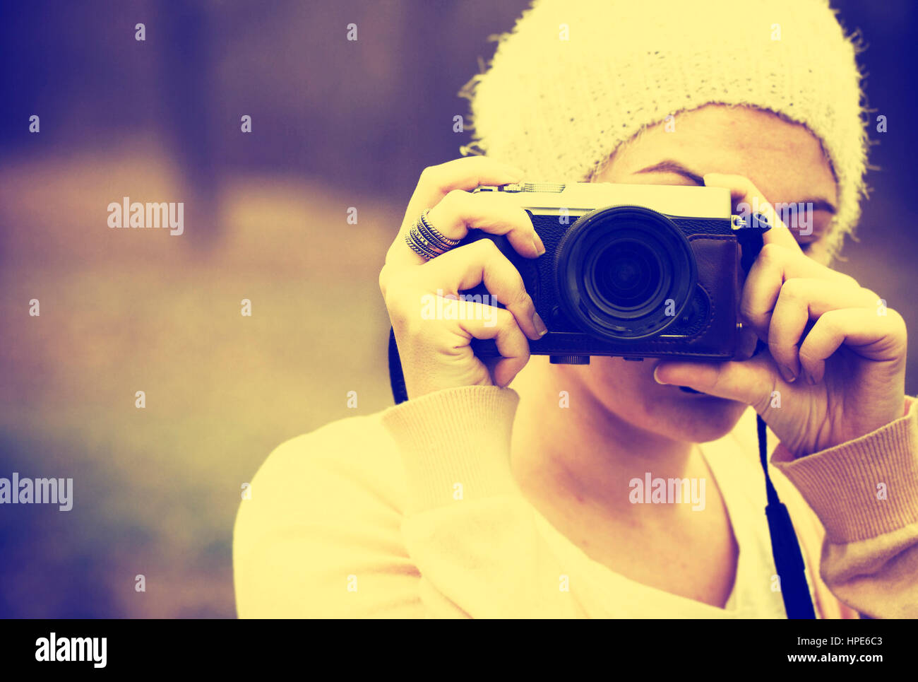 Woman with retro camera in sunset Stock Photo - Alamy