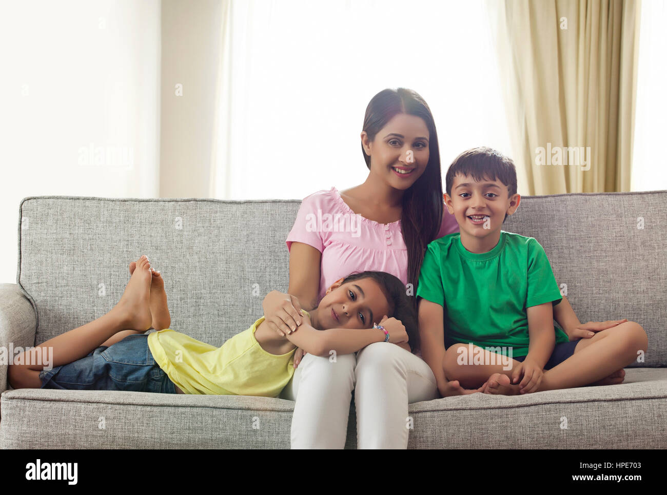 Two girls sitting on sofa hi-res stock photography and images - Alamy