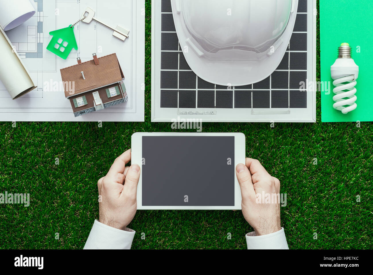 Eco house and sustainable building concept: work tools, solar panel and ...