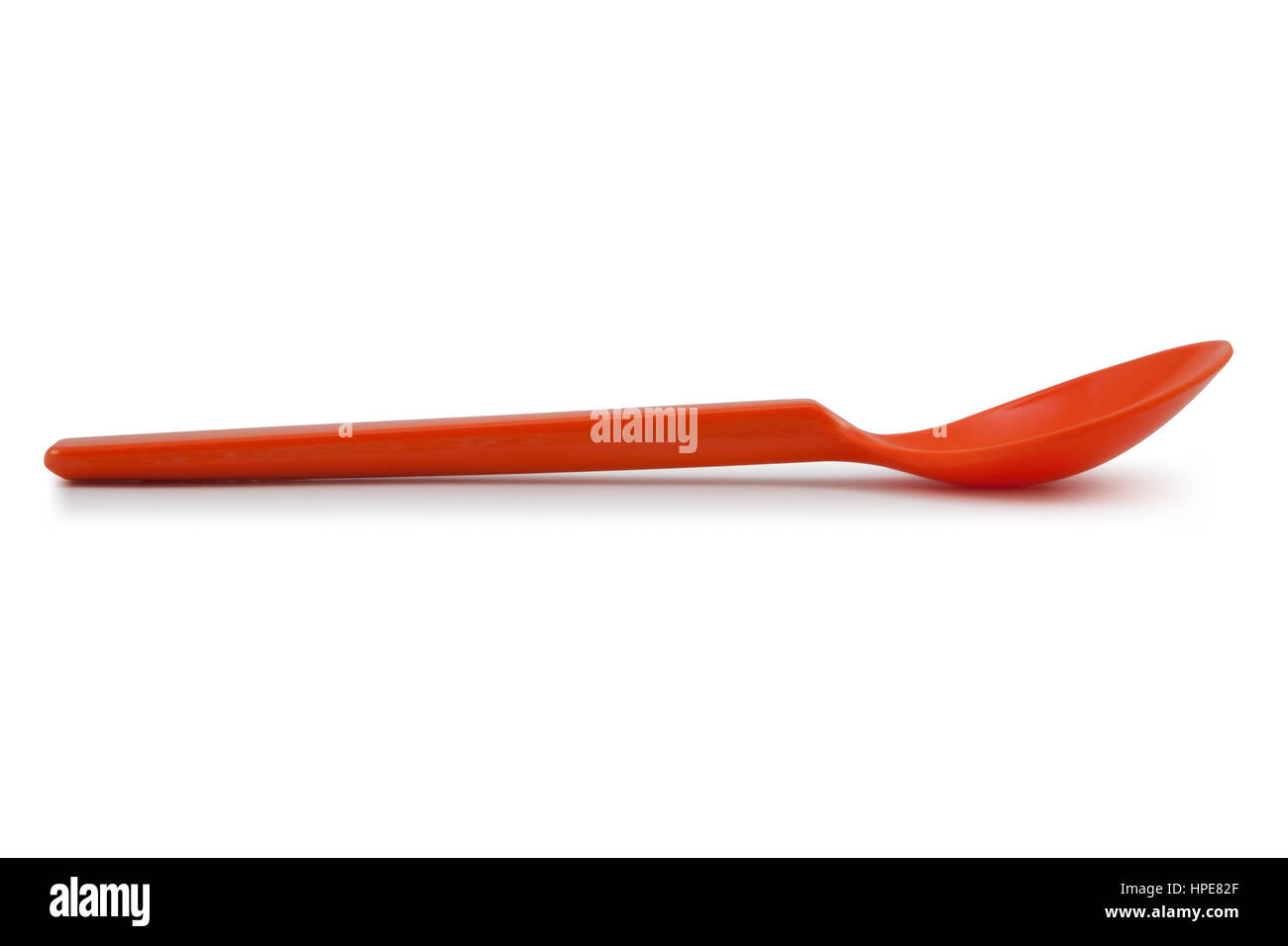 orange plastic spoon on white background Stock Photo - Alamy