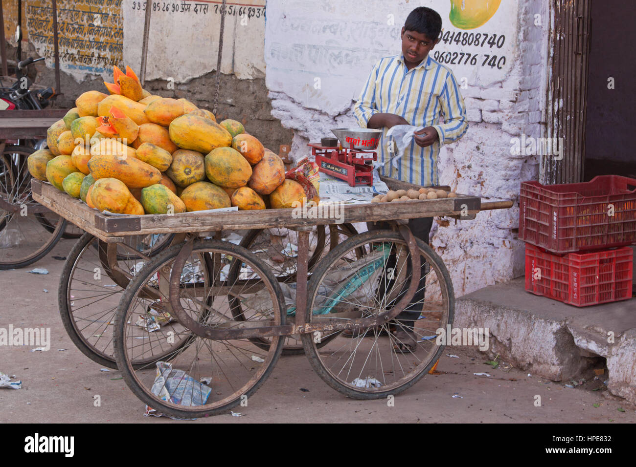 Unidentified barrow boy selling papayas and mangos at a roadside in ...