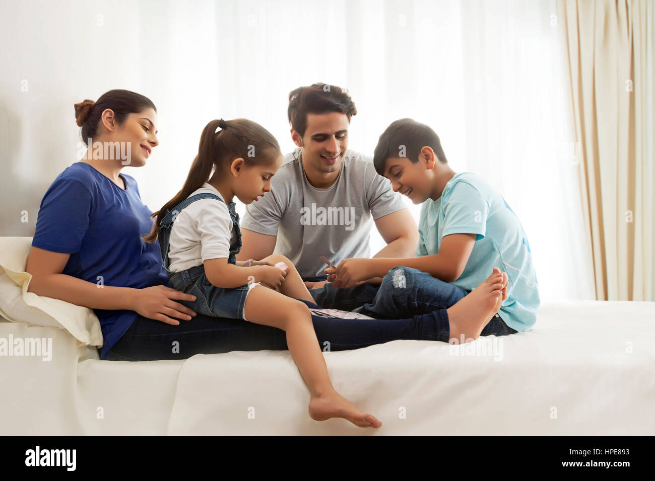 Family playing card game in bed Stock Photo - Alamy