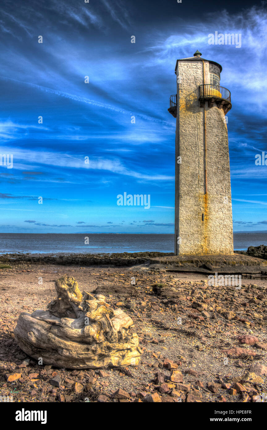 Southerness Lighthouse portrait format and driftwood stump in ...