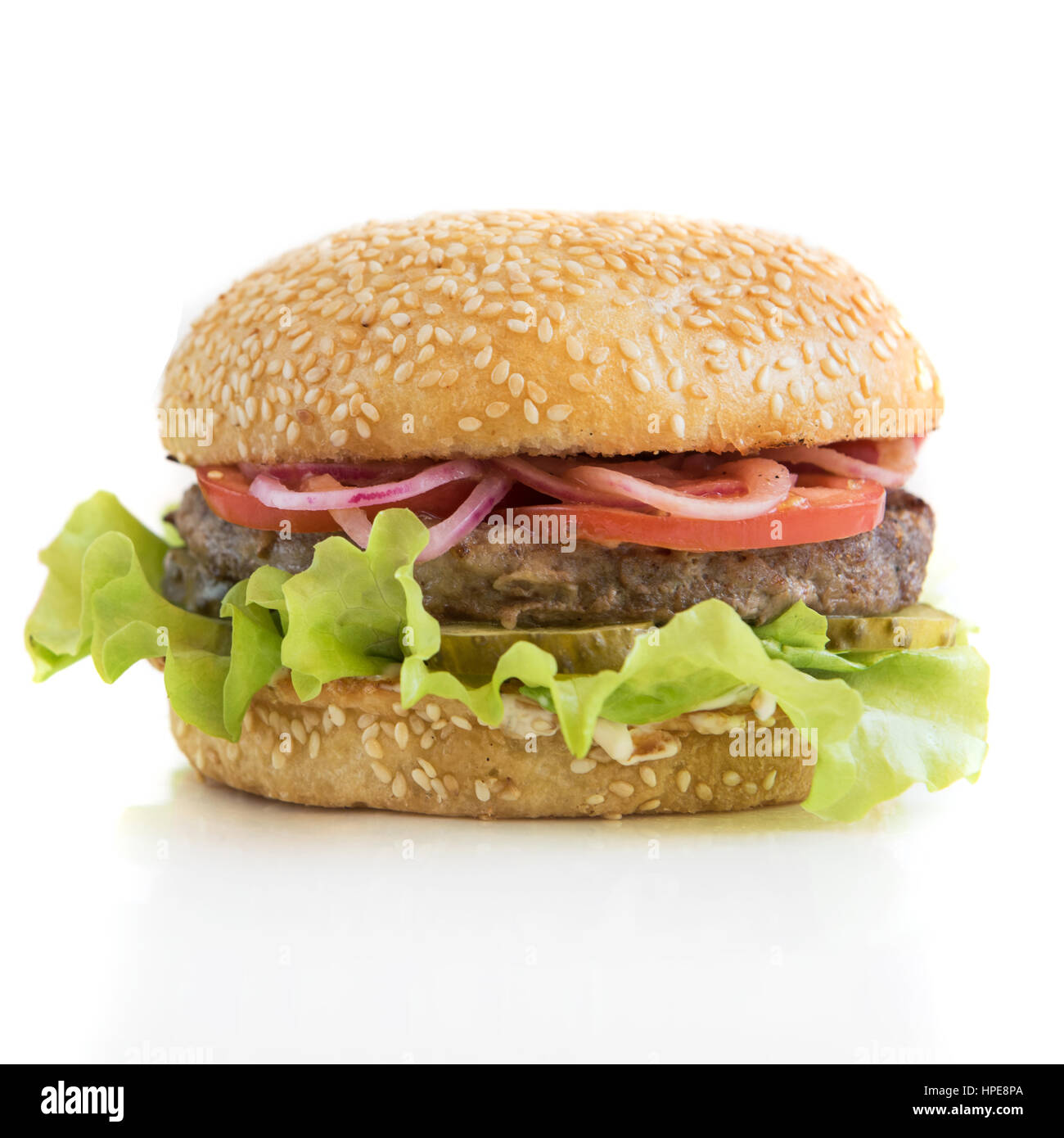 Tasty classical burger with meat cheese lettuce onion, tomato isolated ...