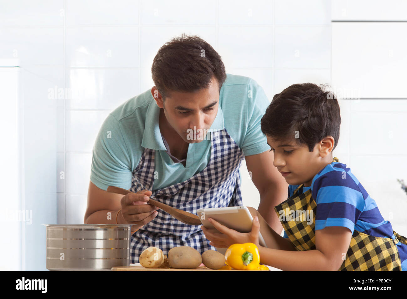 Indian father and son in kitchen hi-res stock photography and images ...