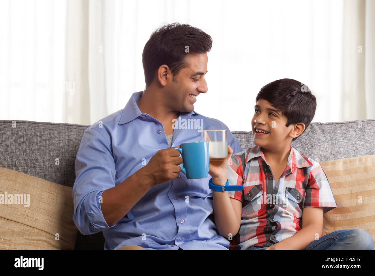 Father and son raising the toast with drinking glasses Stock Photo - Alamy