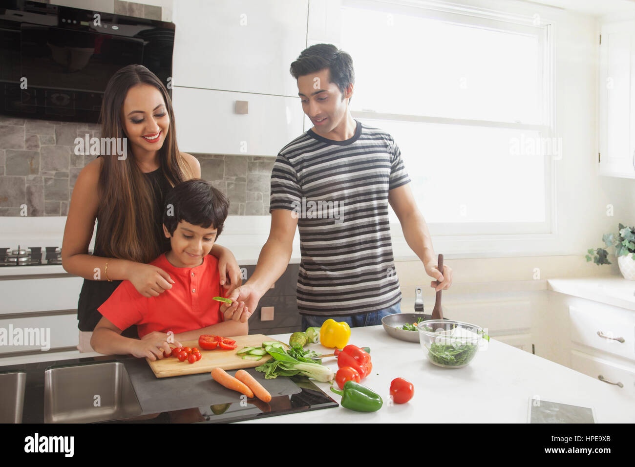 Family cooking in kitchen Stock Photo - Alamy