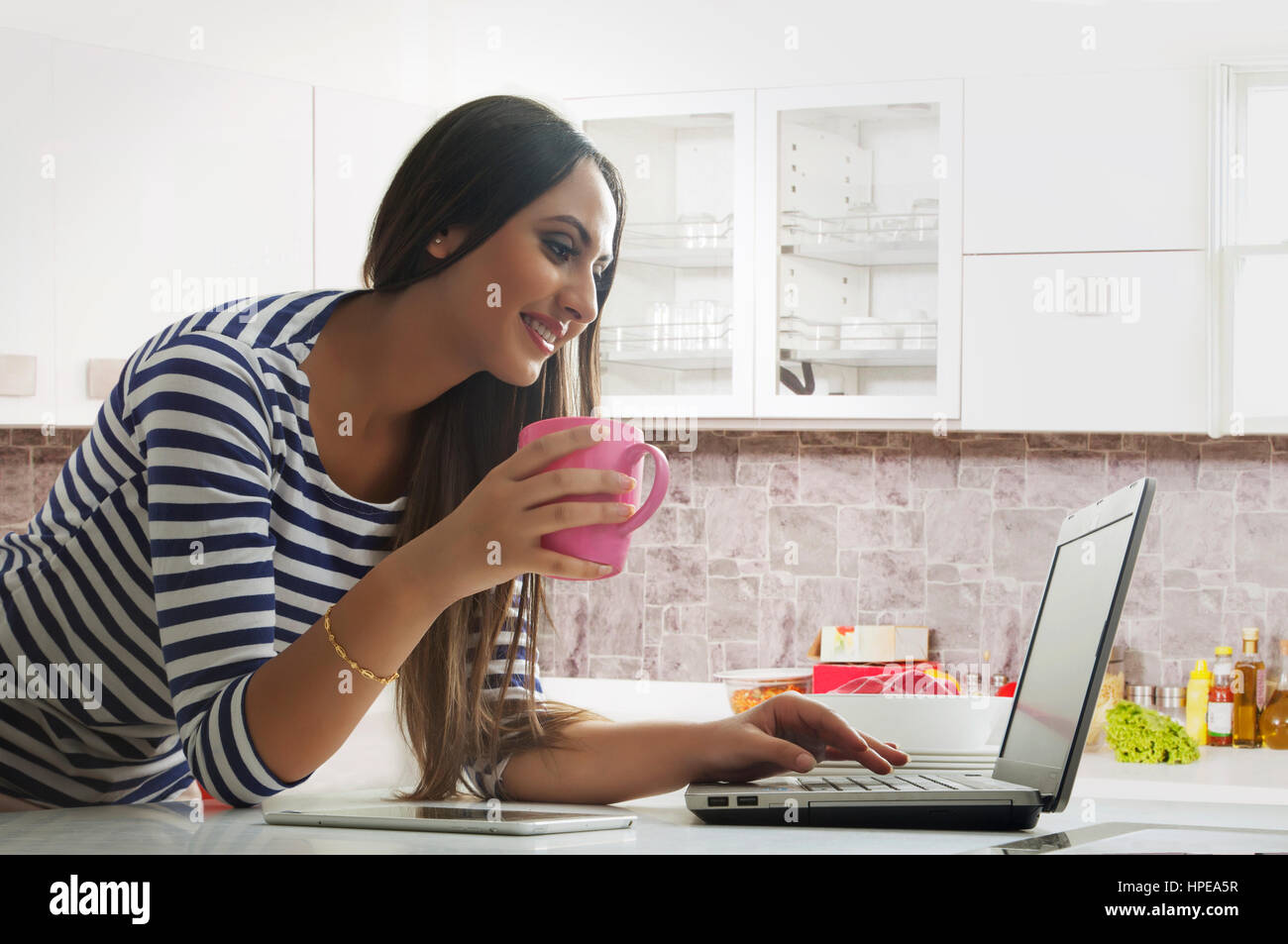 Beautiful asian woman in the kitchen hi-res stock photography and ...