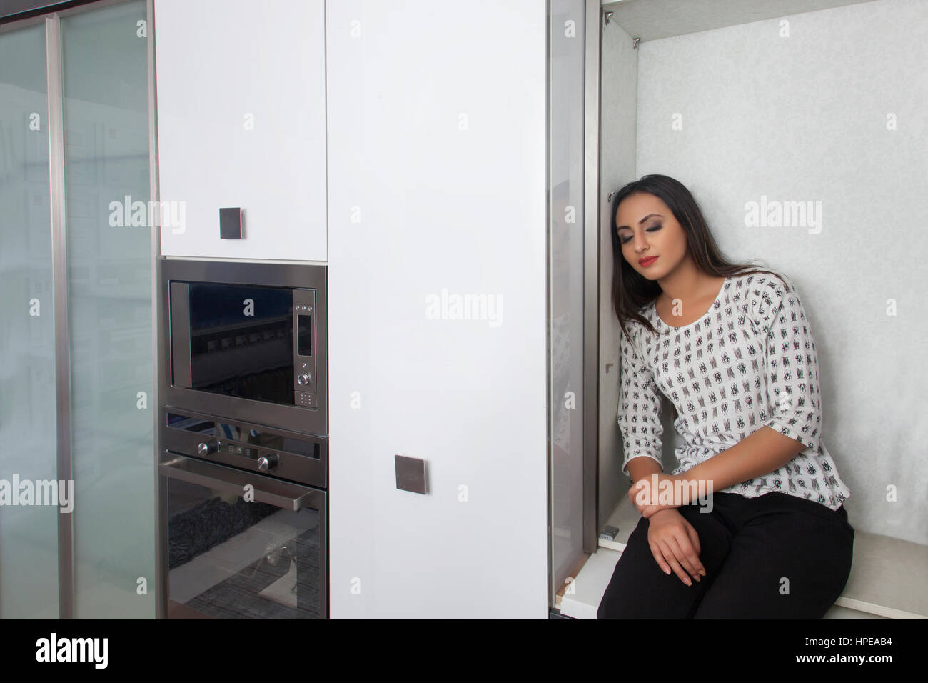 Young woman sleeping in the kitchen Stock Photo - Alamy