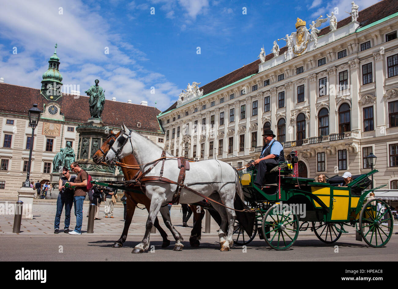 Tourists and Horse carriage in Hofburg Imperial Palace,Vienna, Austria ...
