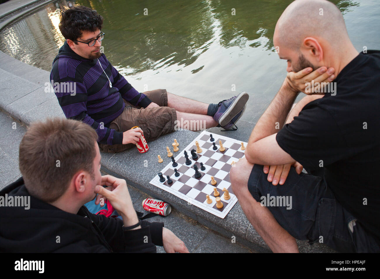Friends playing chess,in front of Karlskirche, St. Charles Borromeo ...