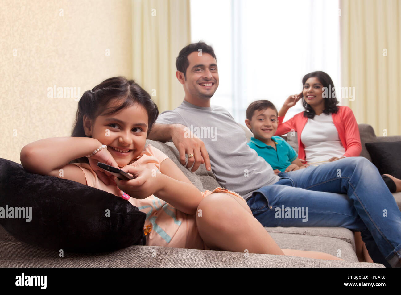 Girls watching tv laughing hi-res stock photography and images - Alamy