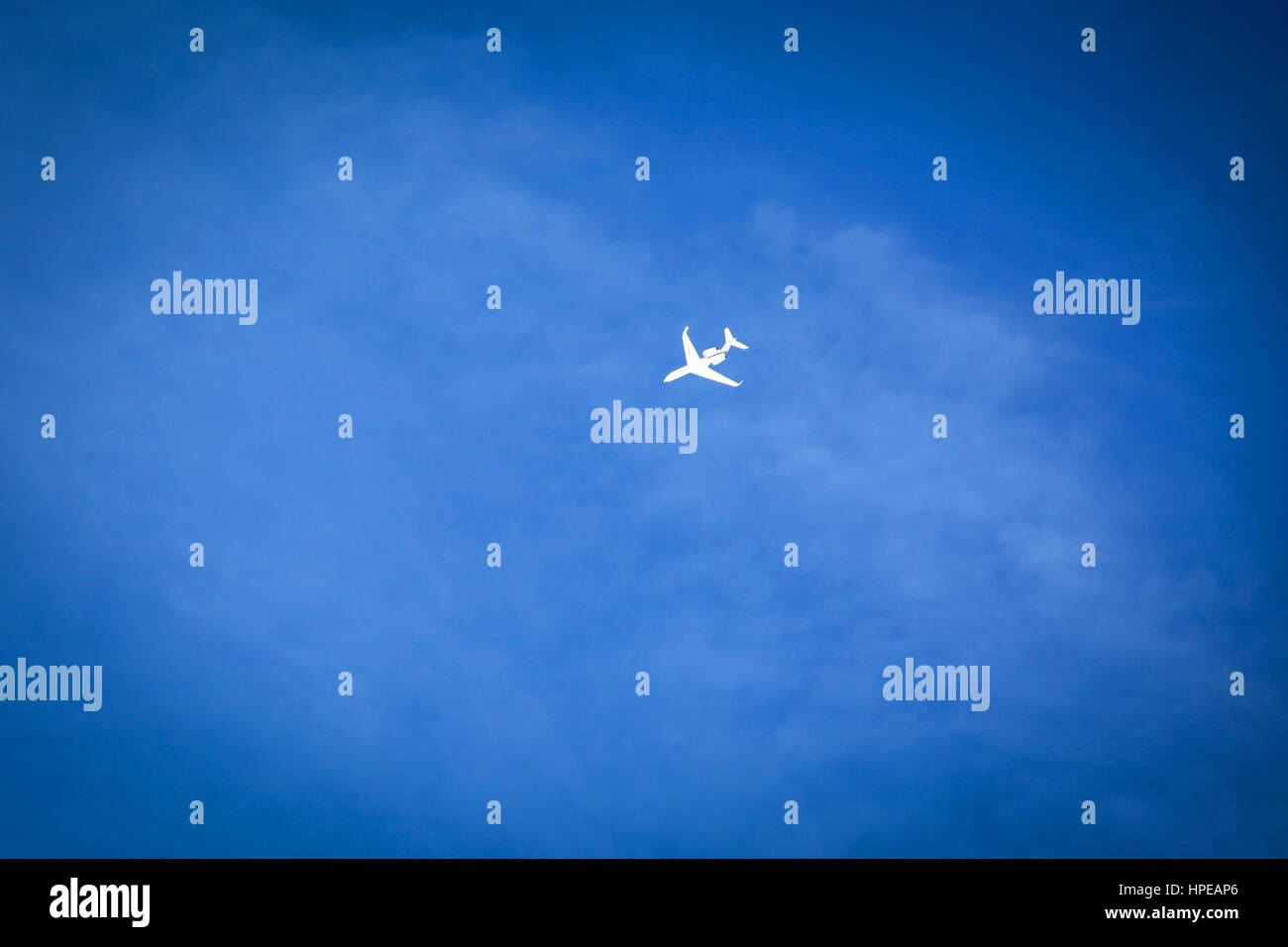 Airplane in the blue sky Stock Photo - Alamy