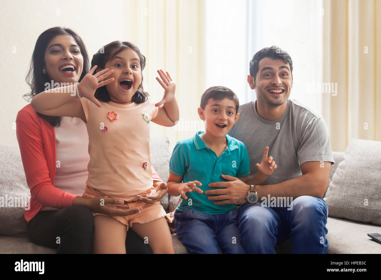 Family watching television together in living room Stock Photo - Alamy