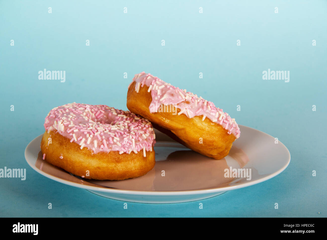 Iced doughnut on a light coloured blue background Stock Photo - Alamy