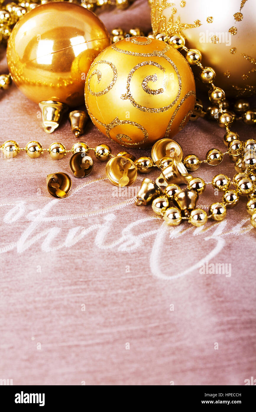 Festive gold Christmas decorations on a fabric background Stock Photo ...