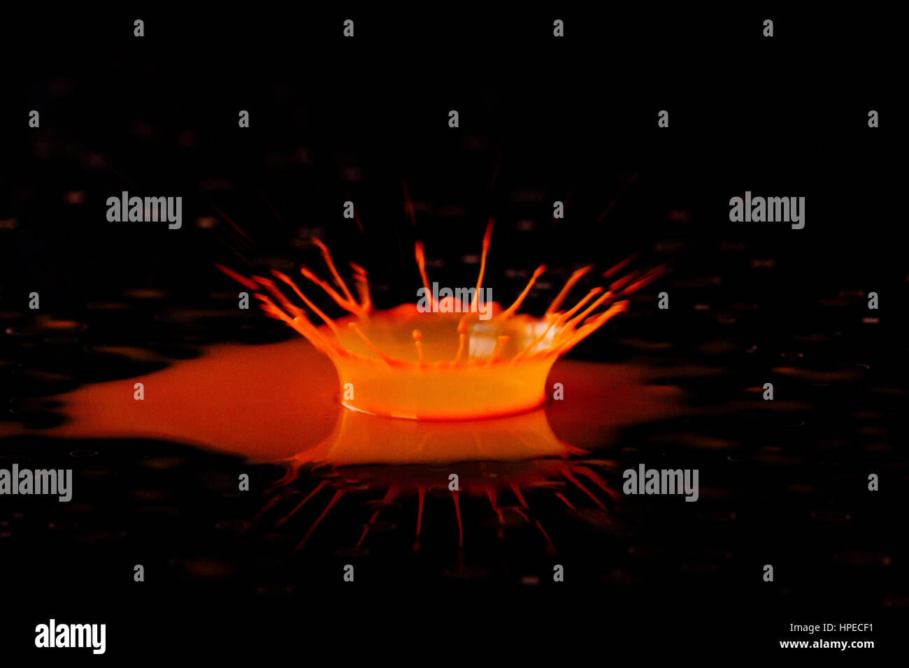 Colorful paint drop splashing on black a background Stock Photo - Alamy