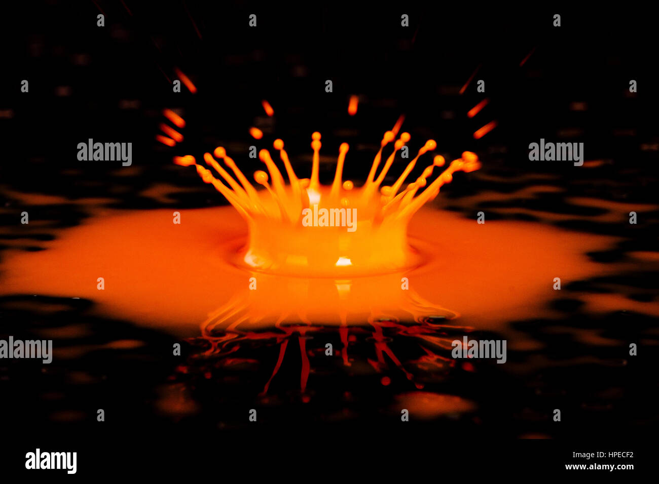 Colorful paint drop splashing on black a background Stock Photo - Alamy