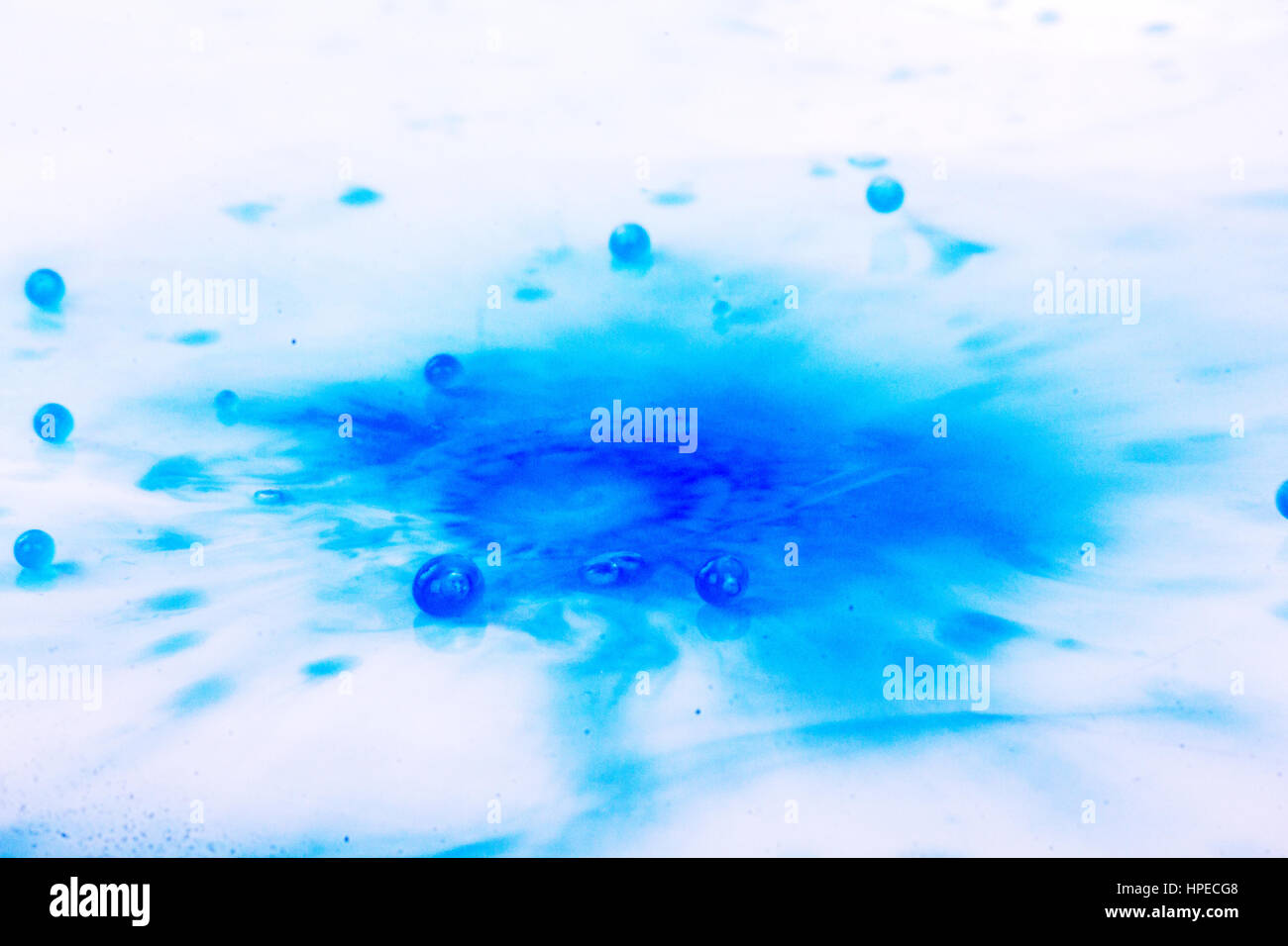 Colorful paint drop splashing on black a background Stock Photo - Alamy