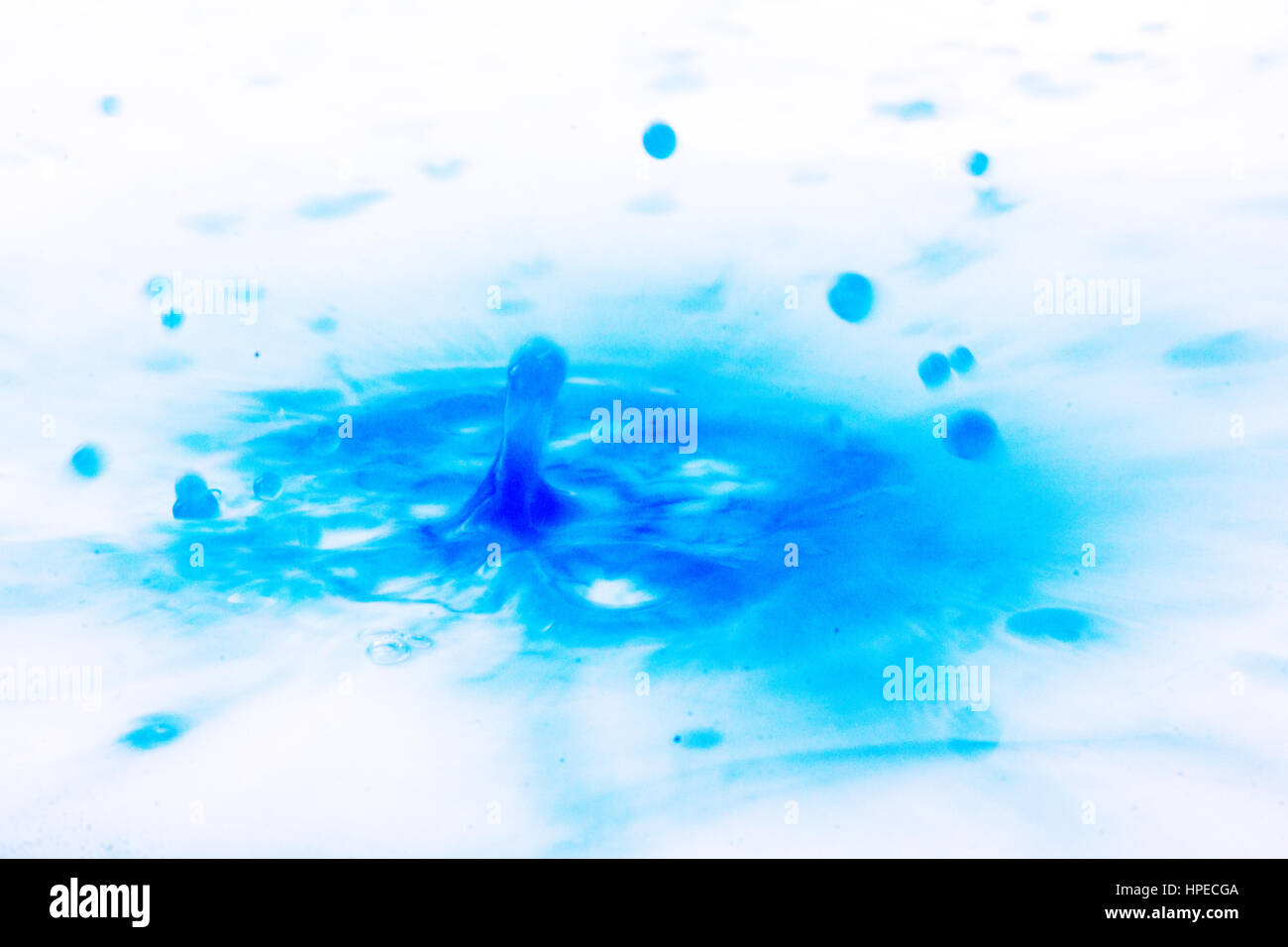 Colorful paint drop splashing on black a background Stock Photo - Alamy