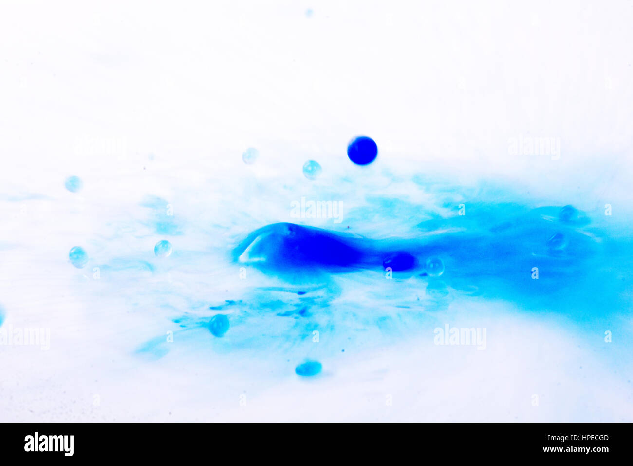 Colorful paint drop splashing on black a background Stock Photo - Alamy