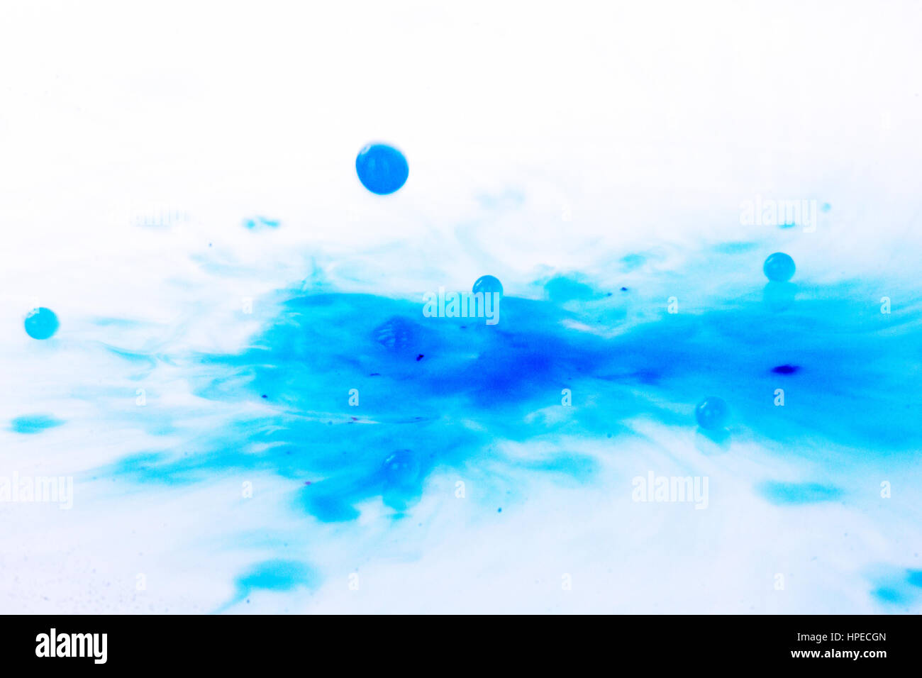 Colorful paint drop splashing on black a background Stock Photo - Alamy
