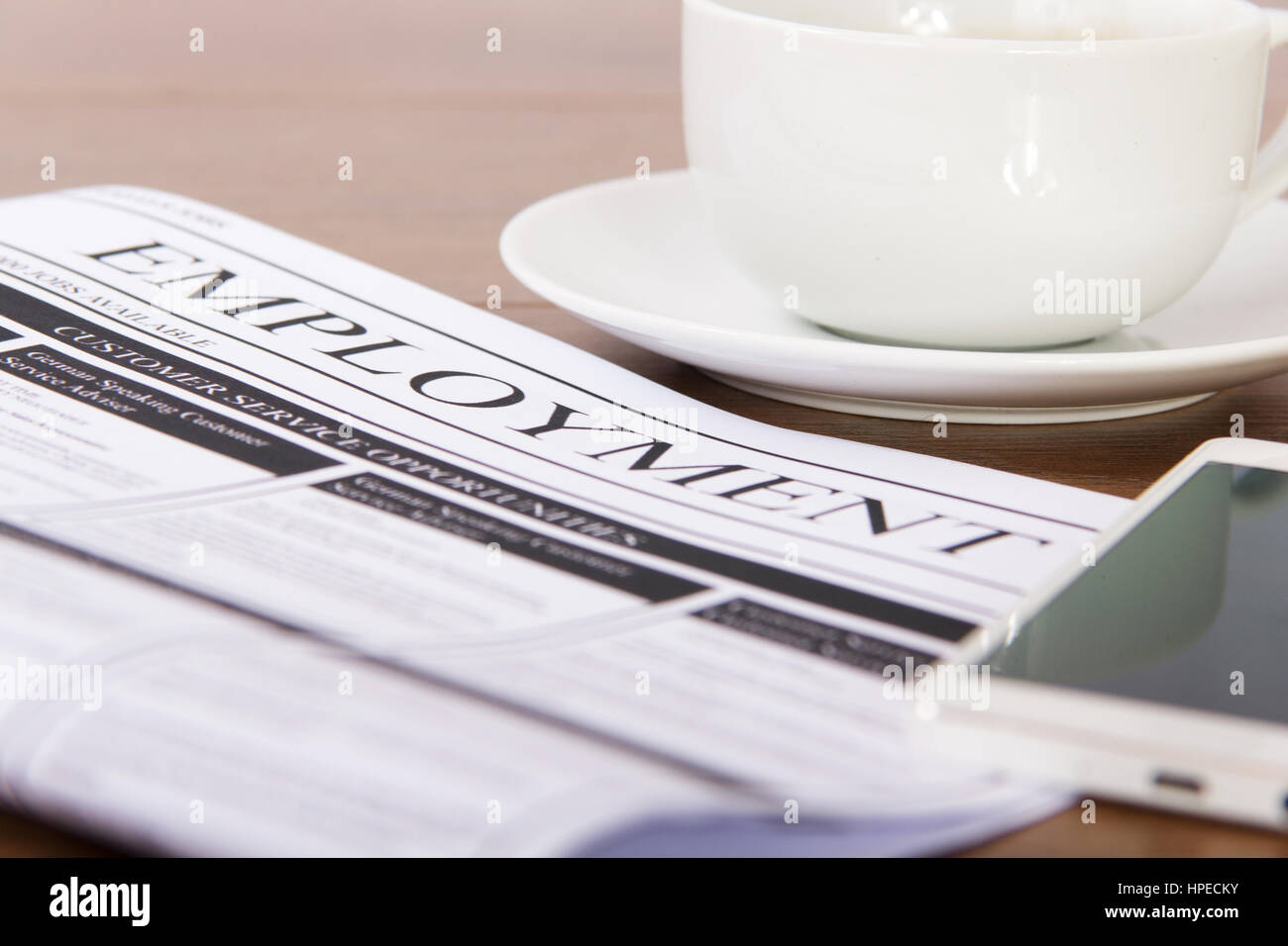 Searching for a new job or employment in a newspaper Stock Photo - Alamy