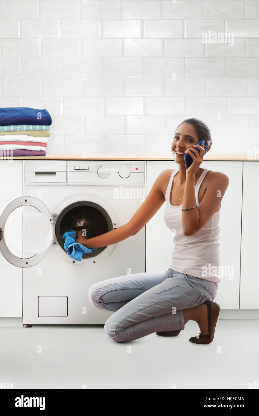 Woman using washing machine hi-res stock photography and images - Alamy