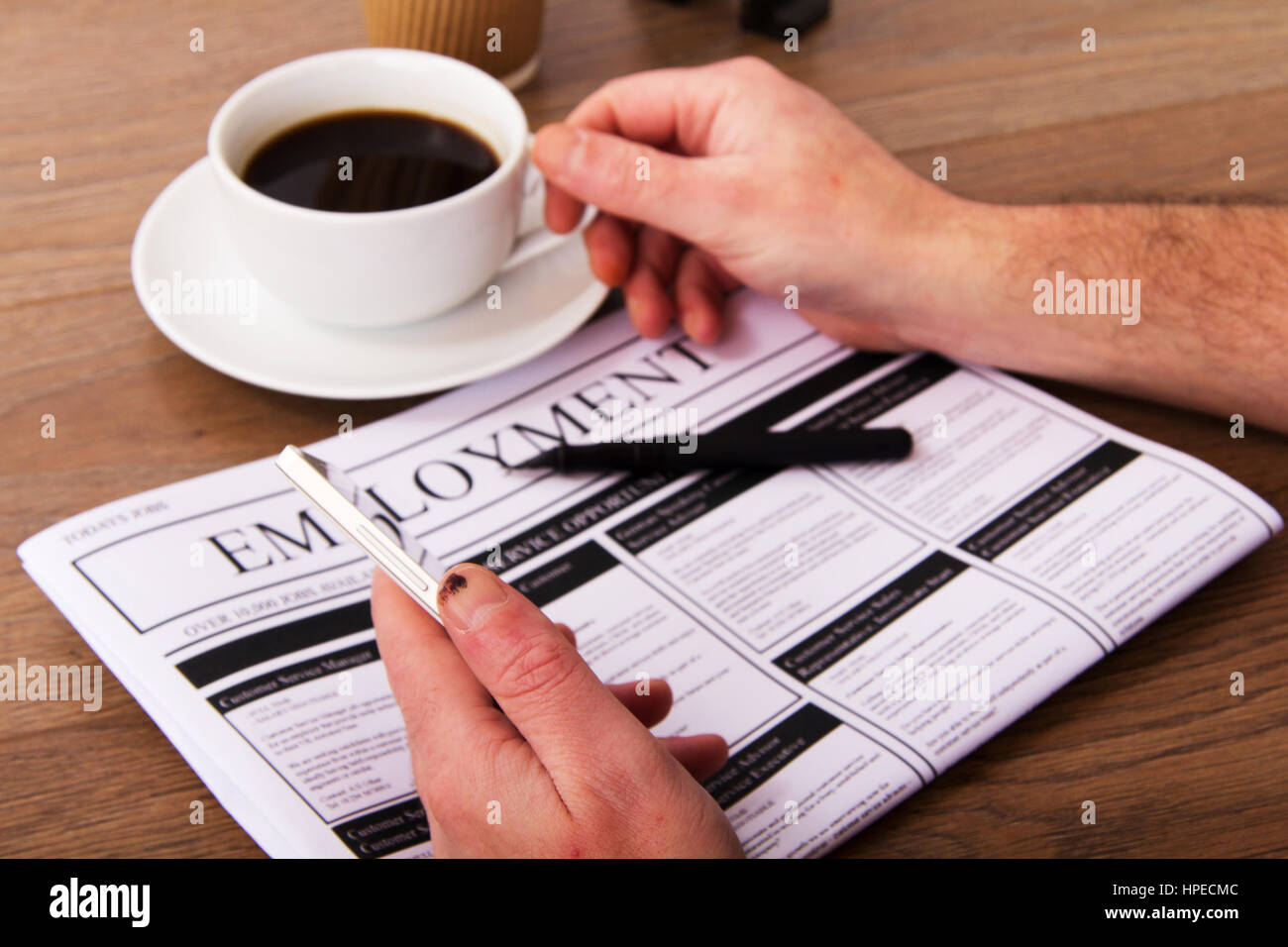 Searching for a new job or employment in a newspaper Stock Photo - Alamy