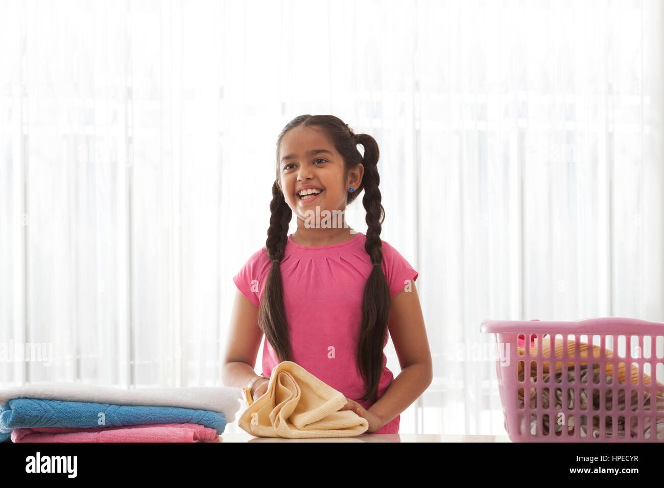 Girl folding laundry Stock Photo - Alamy