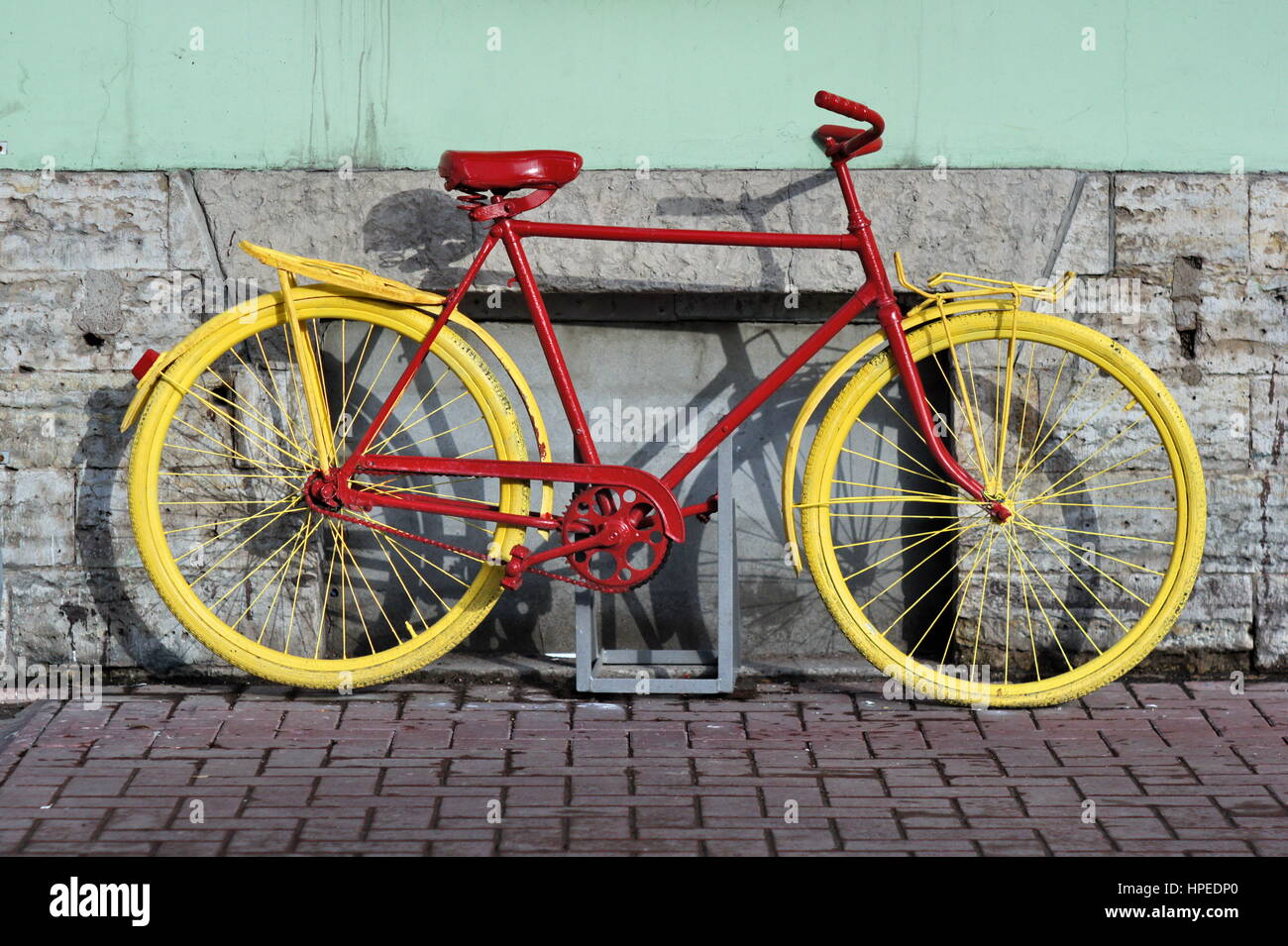 old yellow bicycle stands at the walls the city houses Stock Photo - Alamy